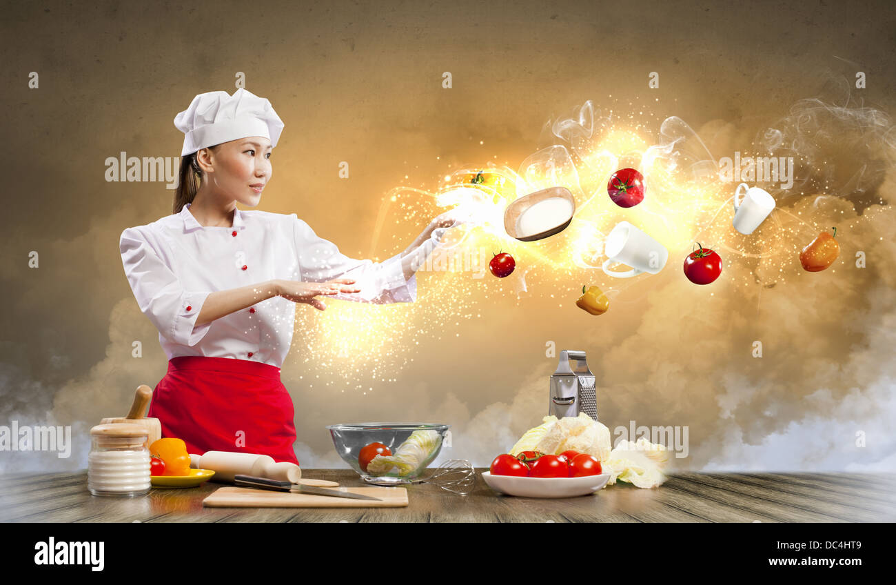Asian female cooking with magic Stock Photo - Alamy