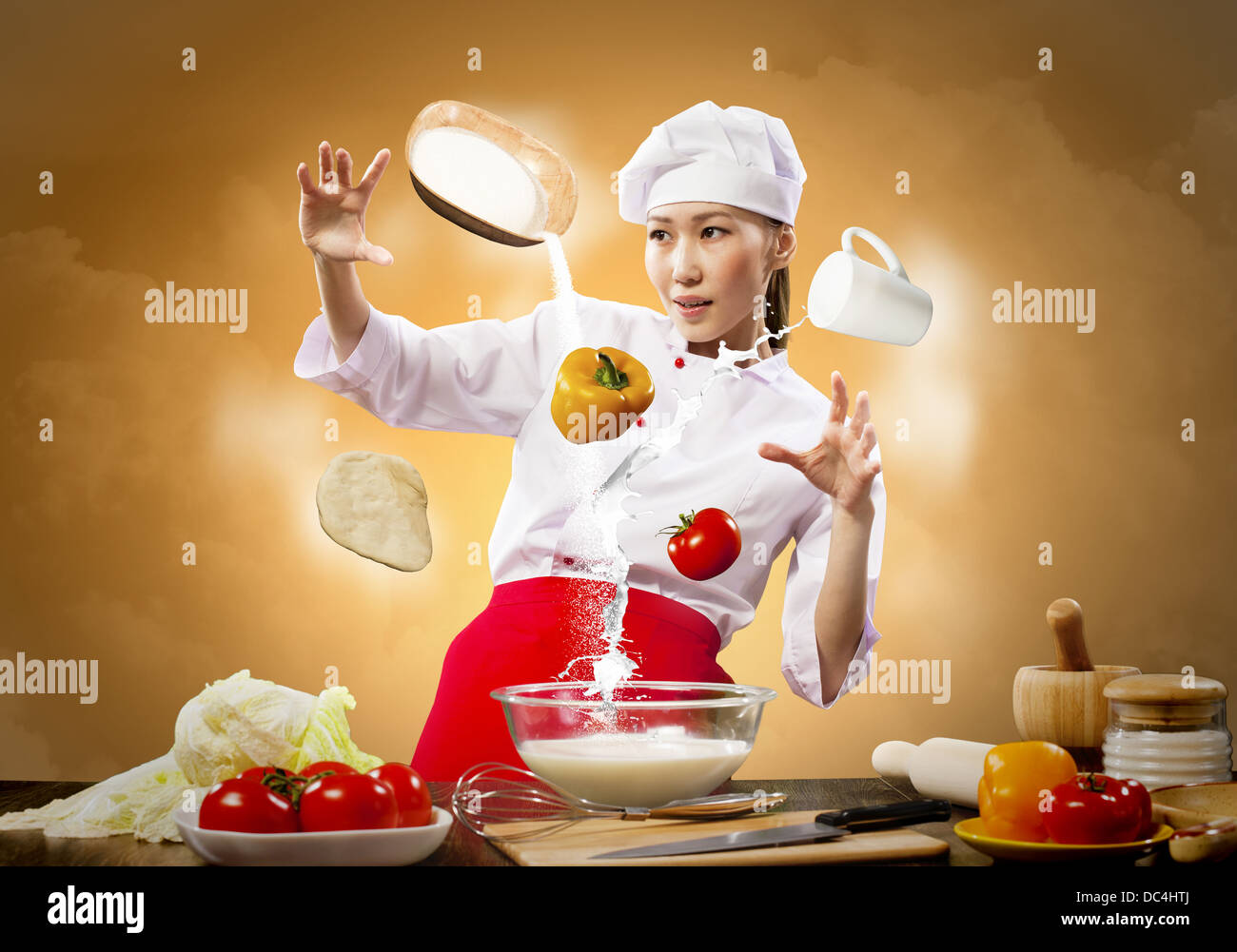 Asian female cooking with magic Stock Photo - Alamy