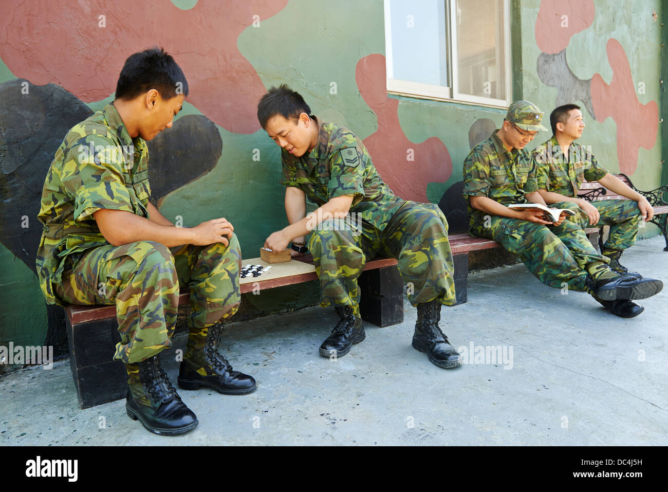 Soldiers relax while playing games and reading magazines on the island ...