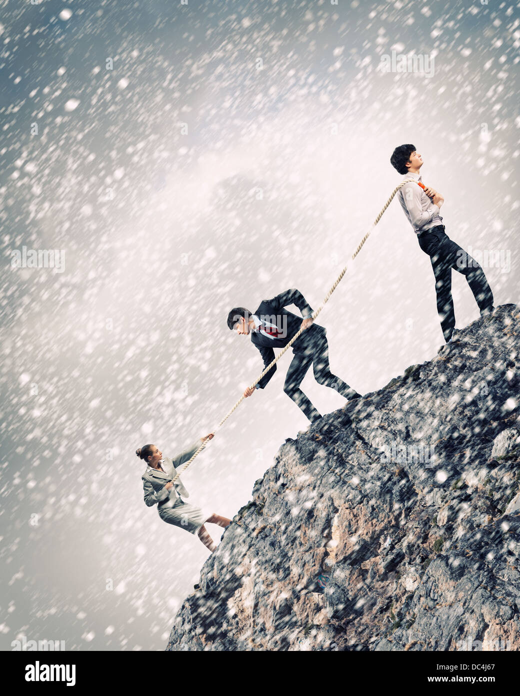 Three business people pulling rope Stock Photo - Alamy