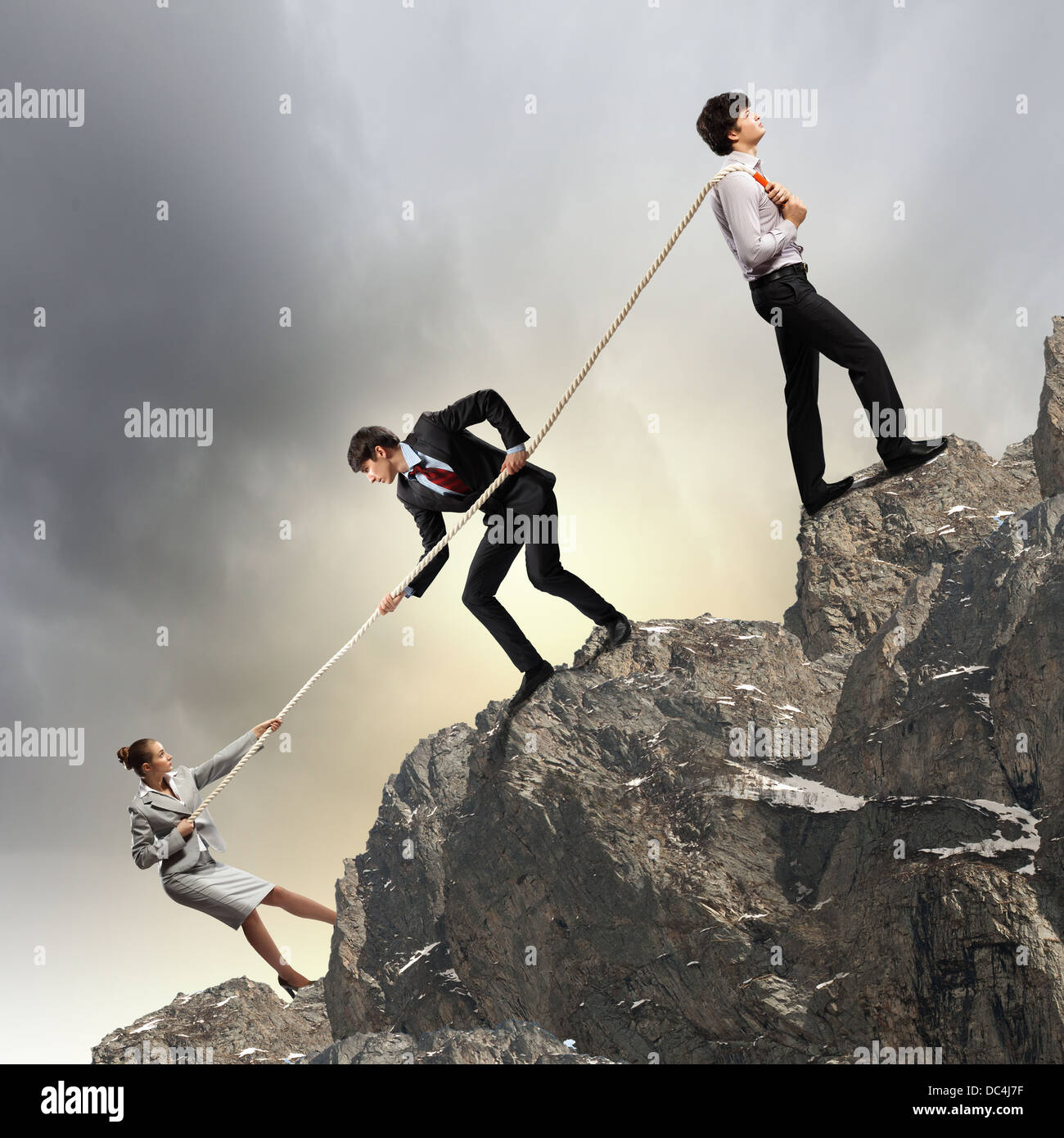 Three business people pulling rope Stock Photo - Alamy