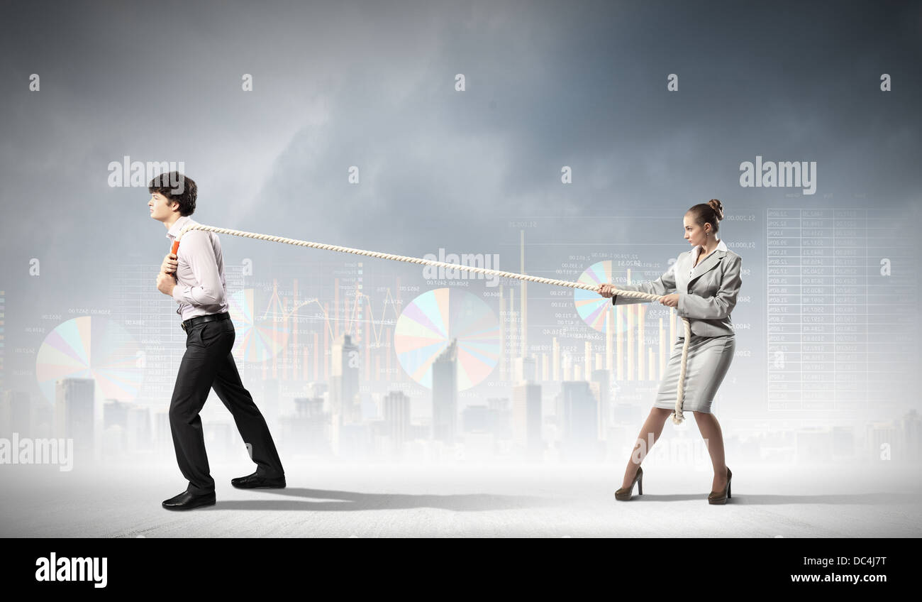 Three business people pulling rope Stock Photo - Alamy