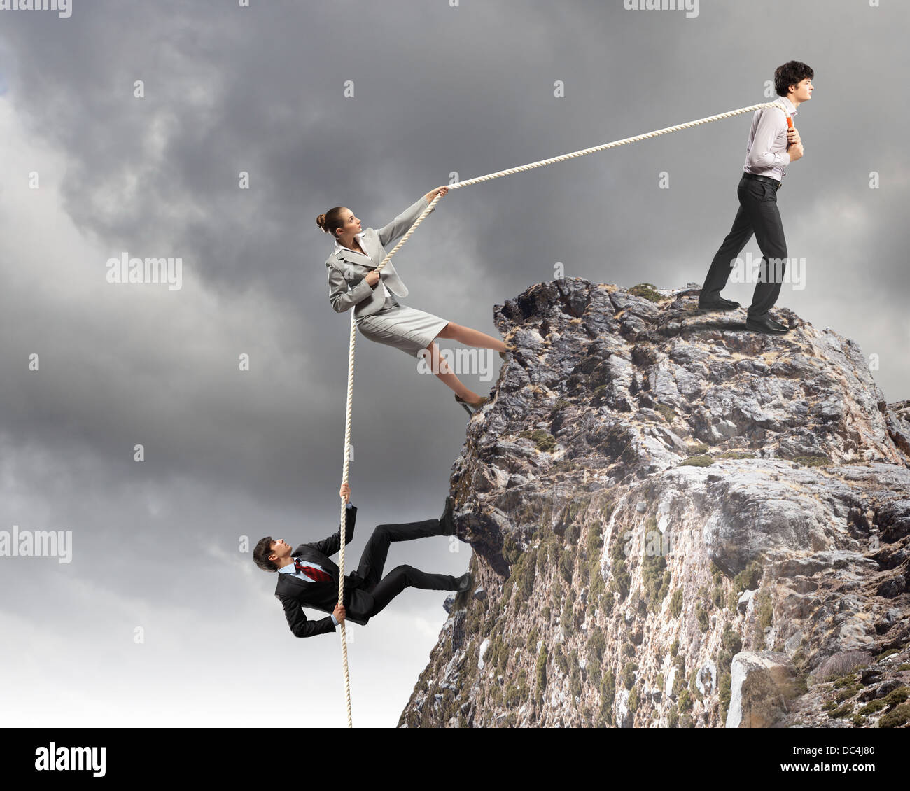 Three business people pulling rope Stock Photo - Alamy
