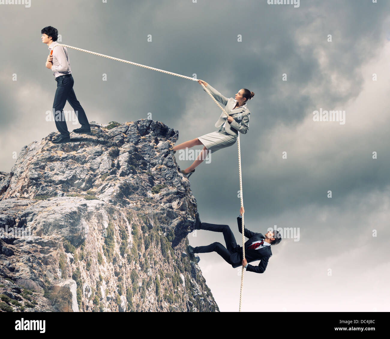 Three business people pulling rope Stock Photo - Alamy