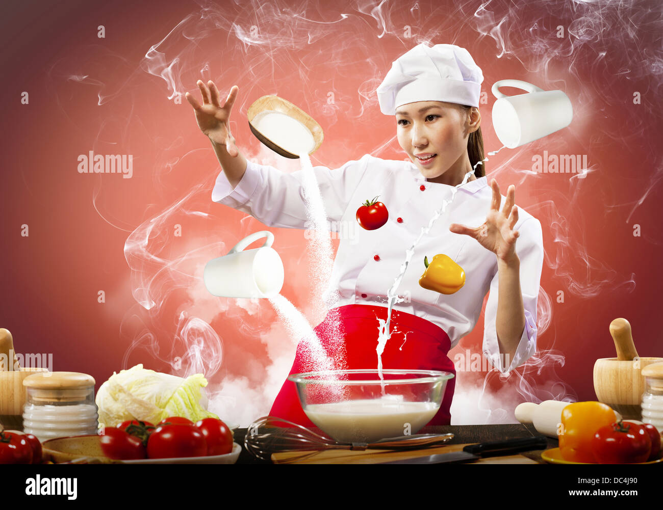 Asian female cooking with magic Stock Photo - Alamy