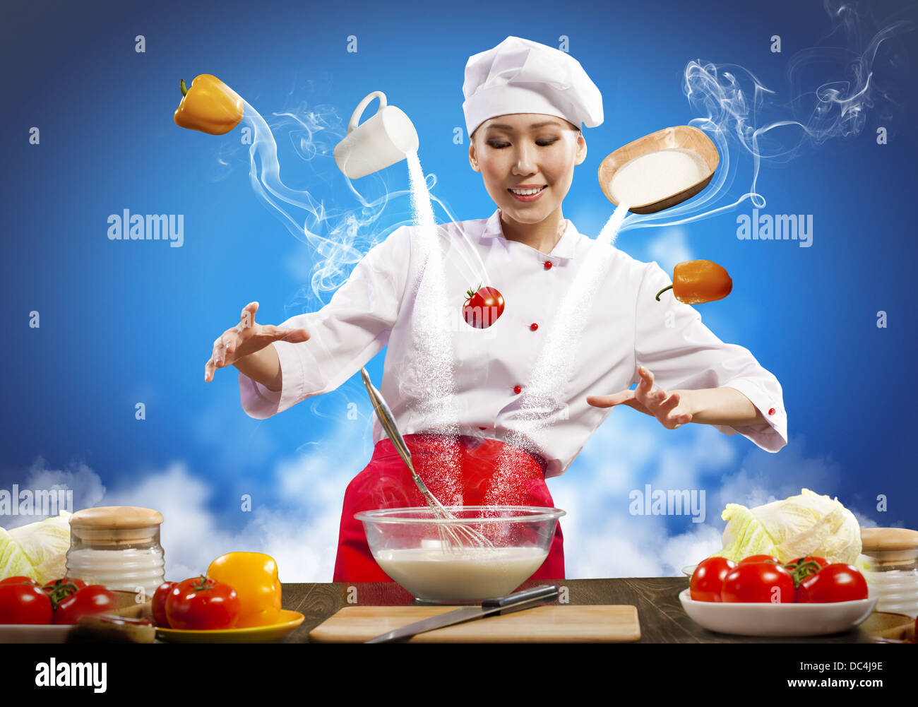 Asian female cooking with magic Stock Photo - Alamy