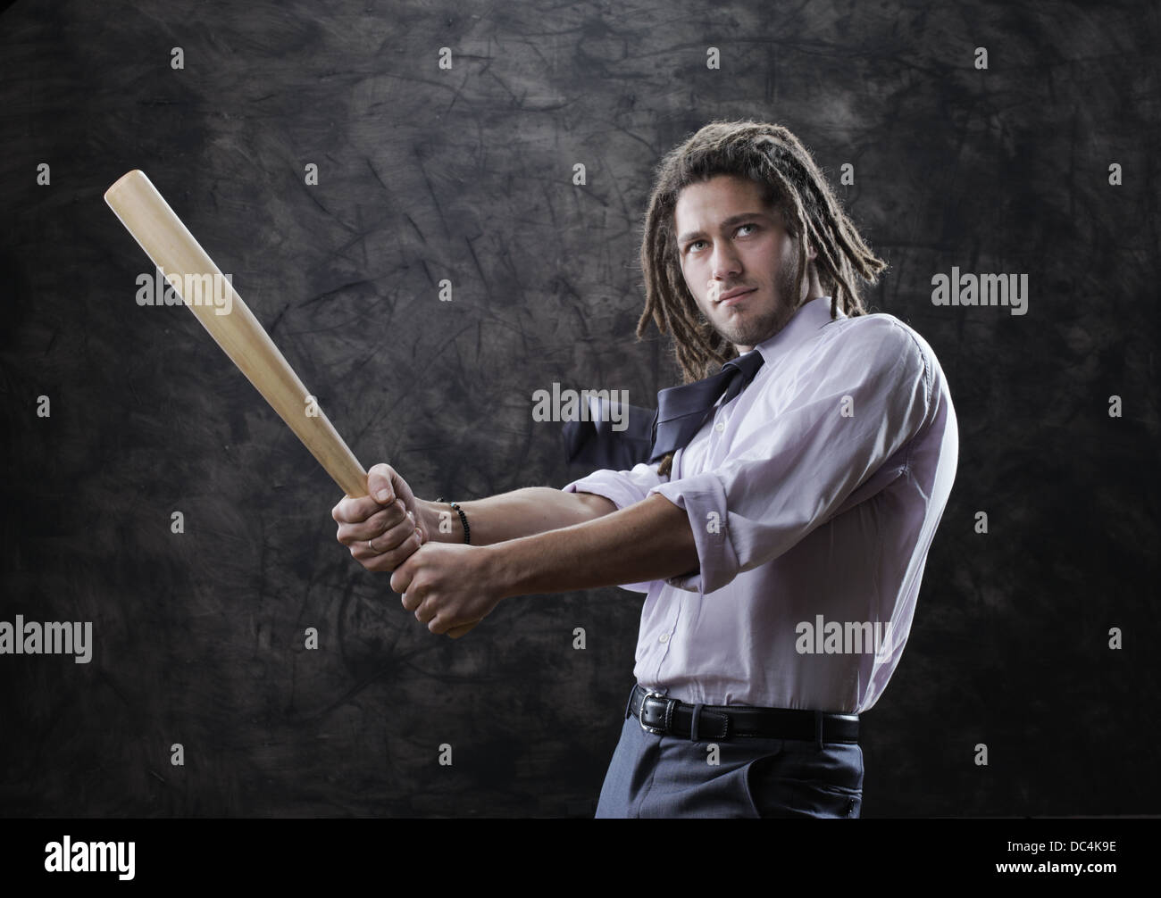 Businessman swinging baseball bat Stock Photo - Alamy