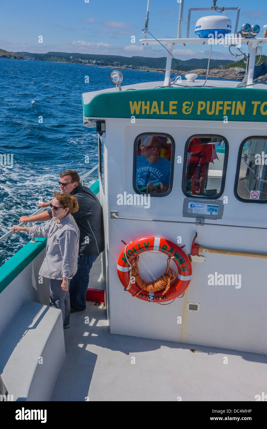 A man and woman look out to sea aboard the boat for Molly Bawn Whale ...