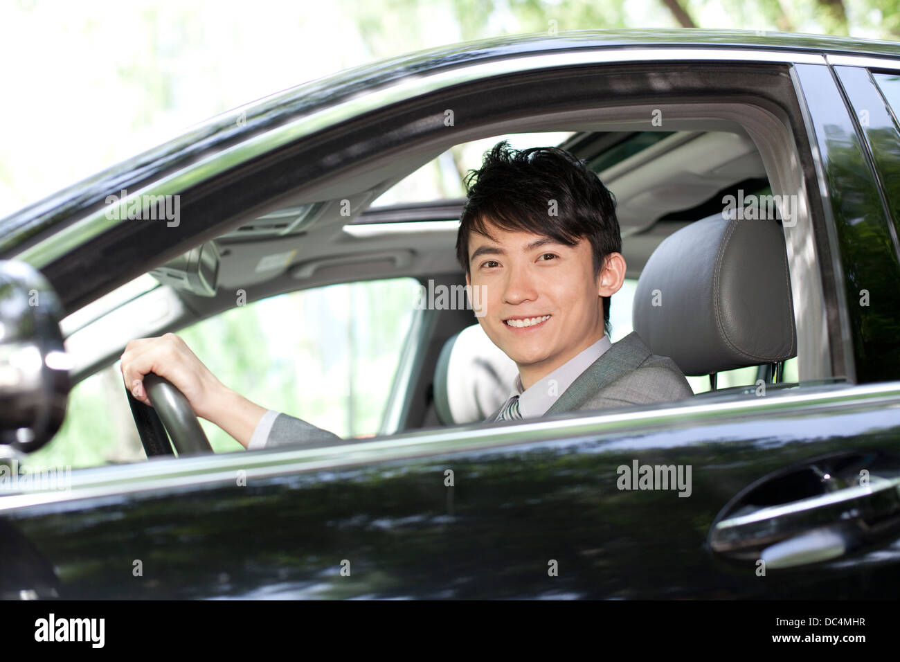 Businessman driving car Stock Photo - Alamy