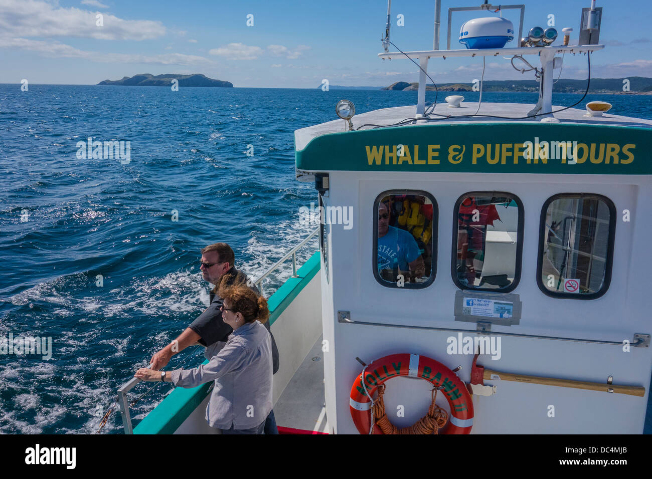 A man and woman look out to sea aboard the boat for Molly Bawn Whale ...