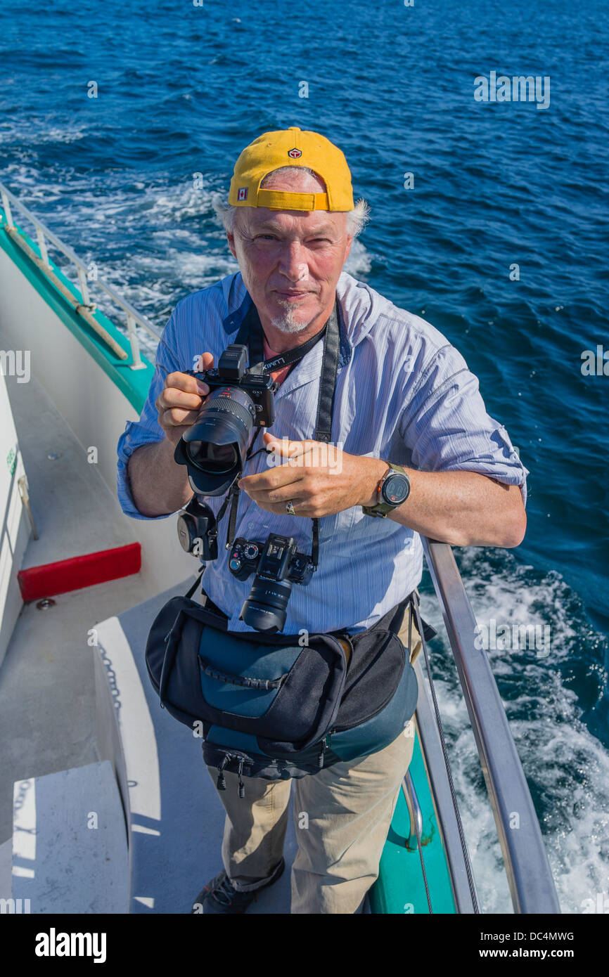 Photographer Tim Benson readies his camera to take a wildlife ...