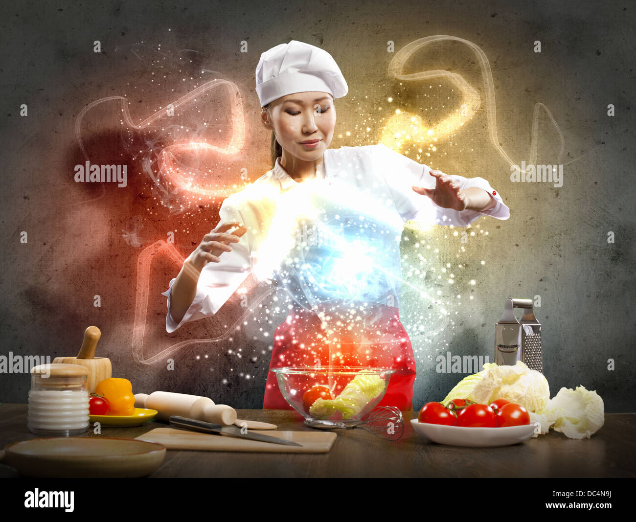 Asian female cooking with magic Stock Photo - Alamy