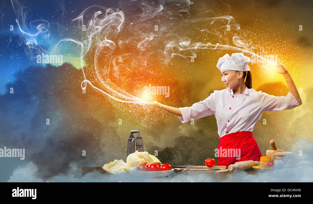 Asian female cooking with magic Stock Photo - Alamy