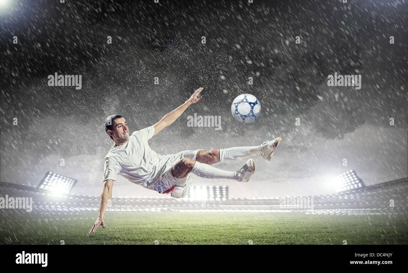 football player striking the ball Stock Photo - Alamy