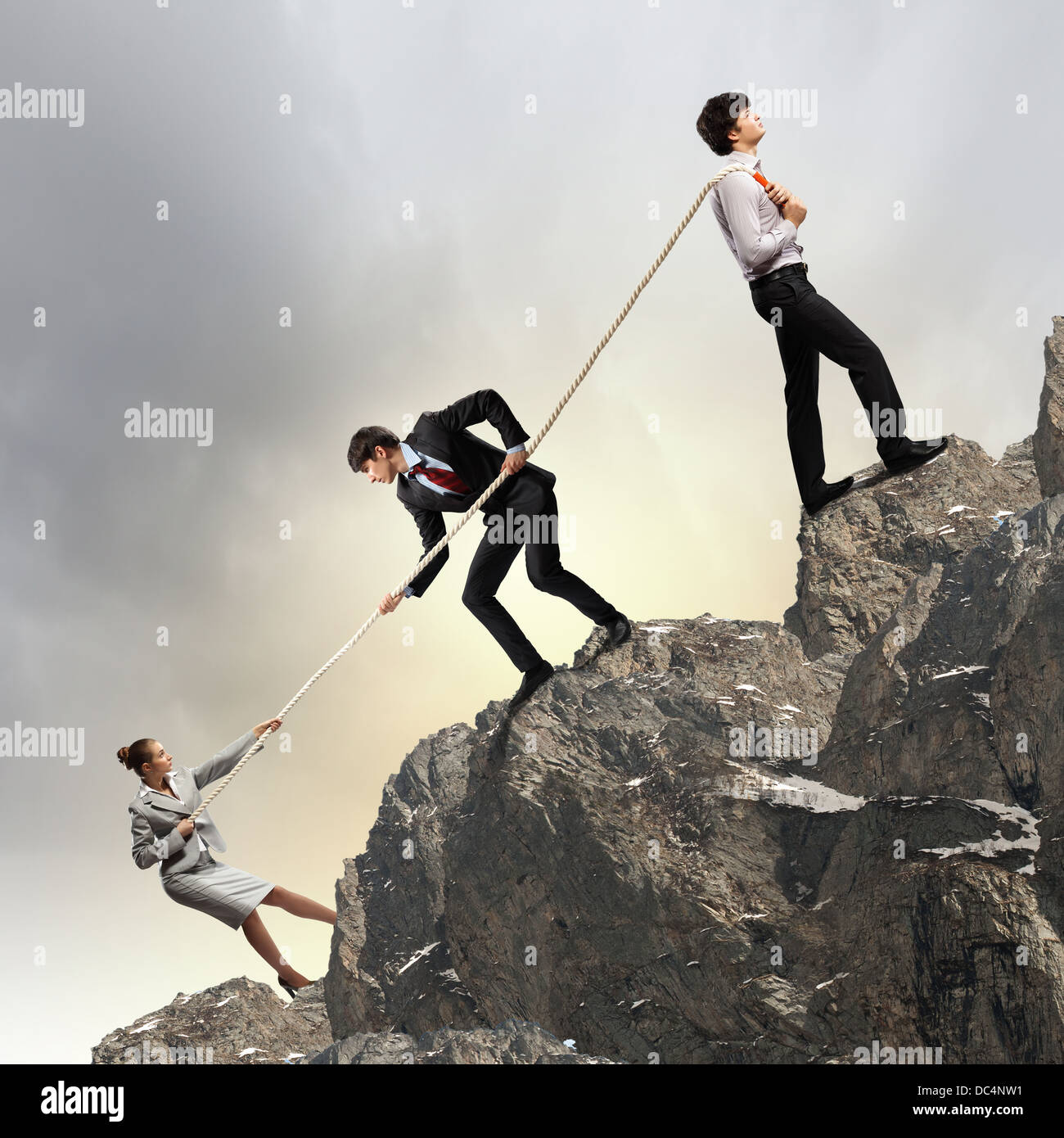 Three business people pulling rope Stock Photo - Alamy