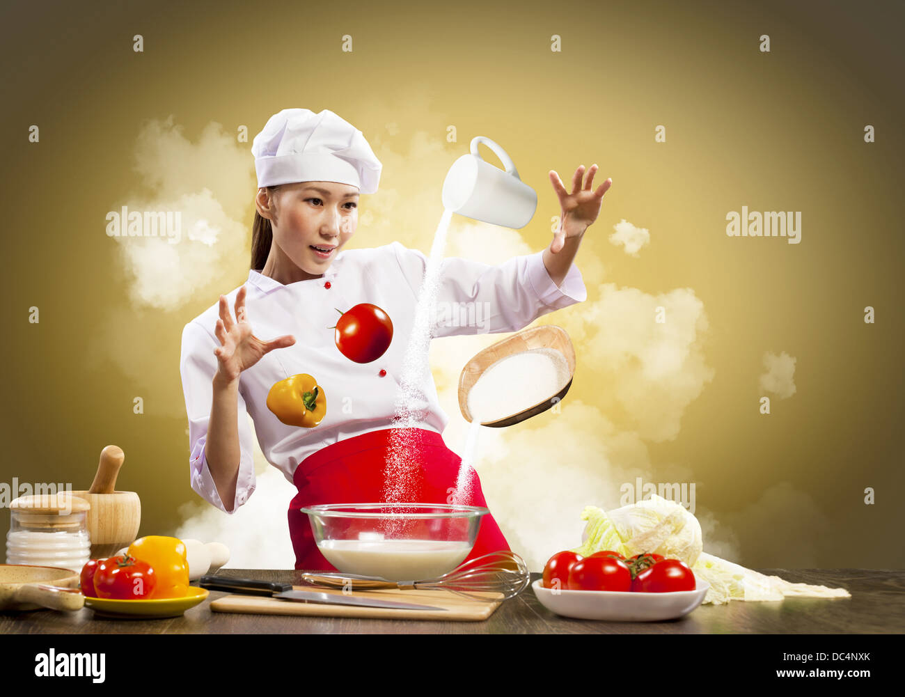 Asian female cooking with magic Stock Photo - Alamy