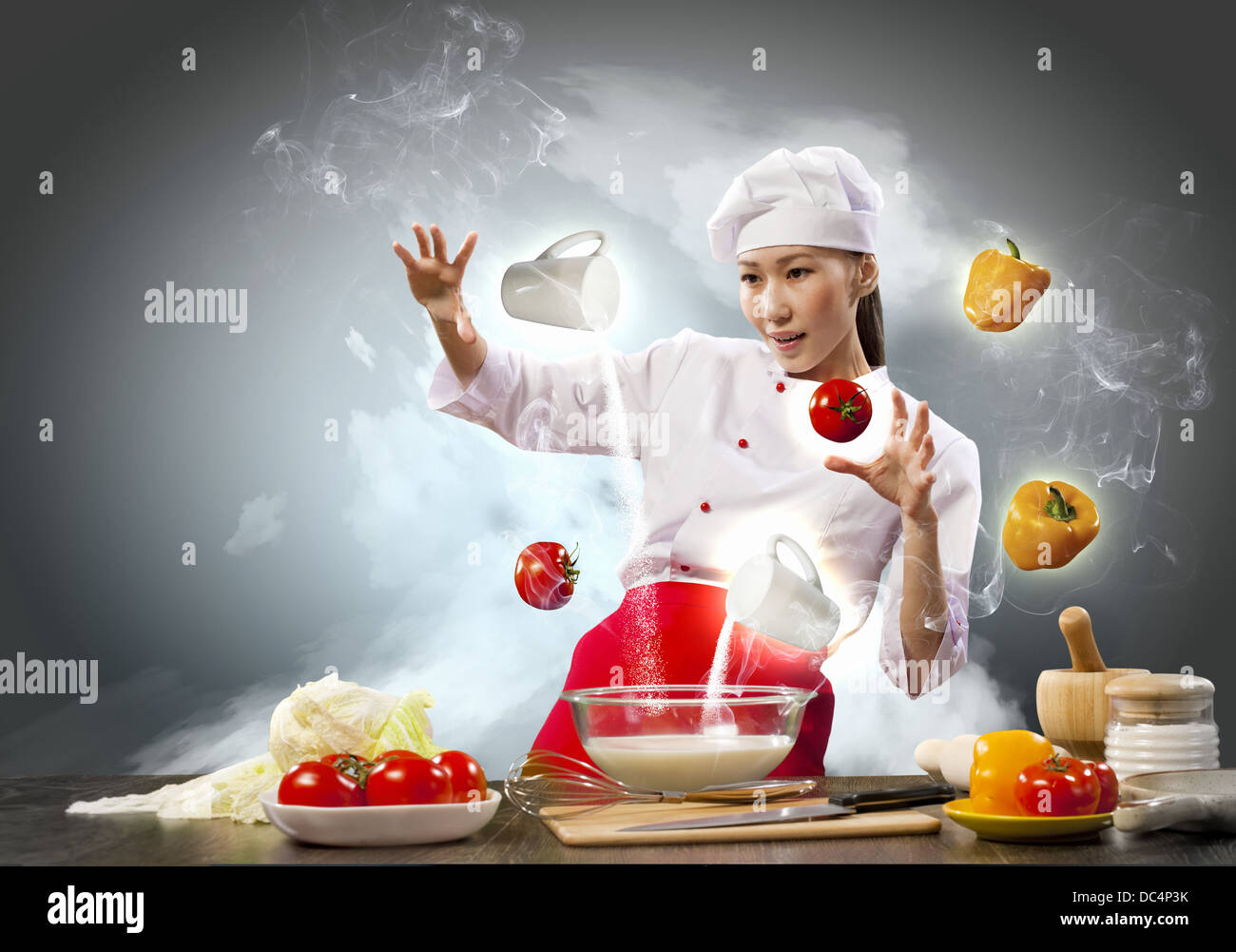 Asian female cooking with magic Stock Photo - Alamy