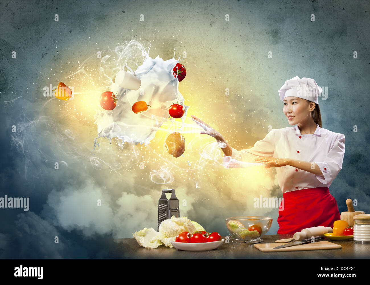 Asian female cooking with magic Stock Photo - Alamy