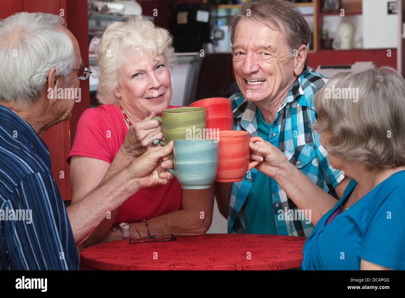 Senior Adults Toasting with Mugs Stock Photo - Alamy