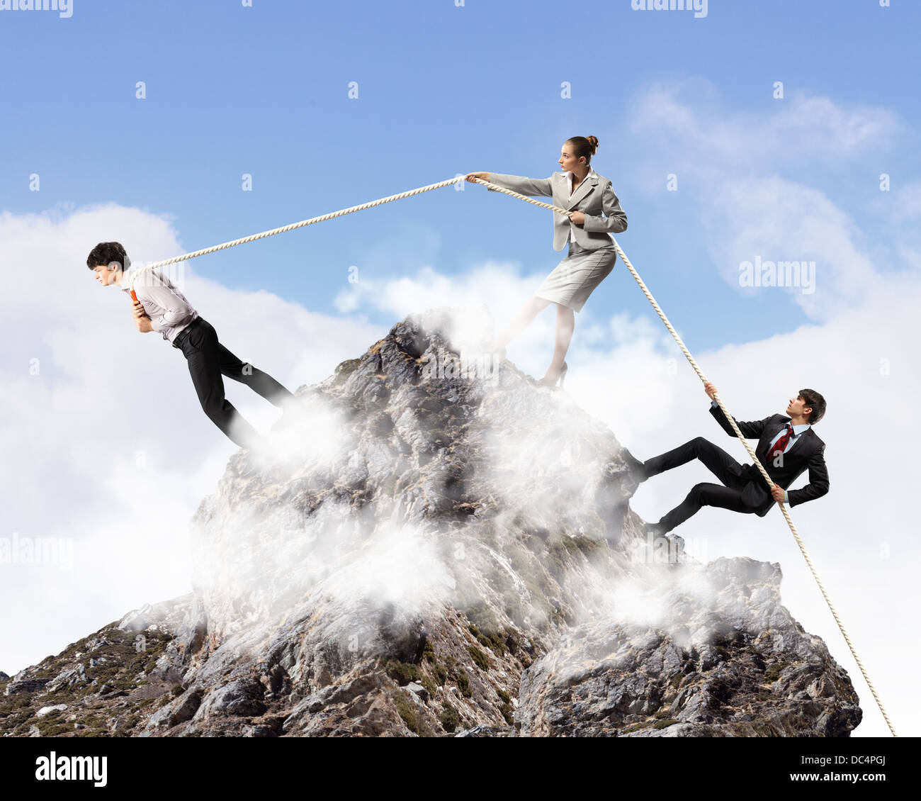 Three business people pulling rope Stock Photo - Alamy