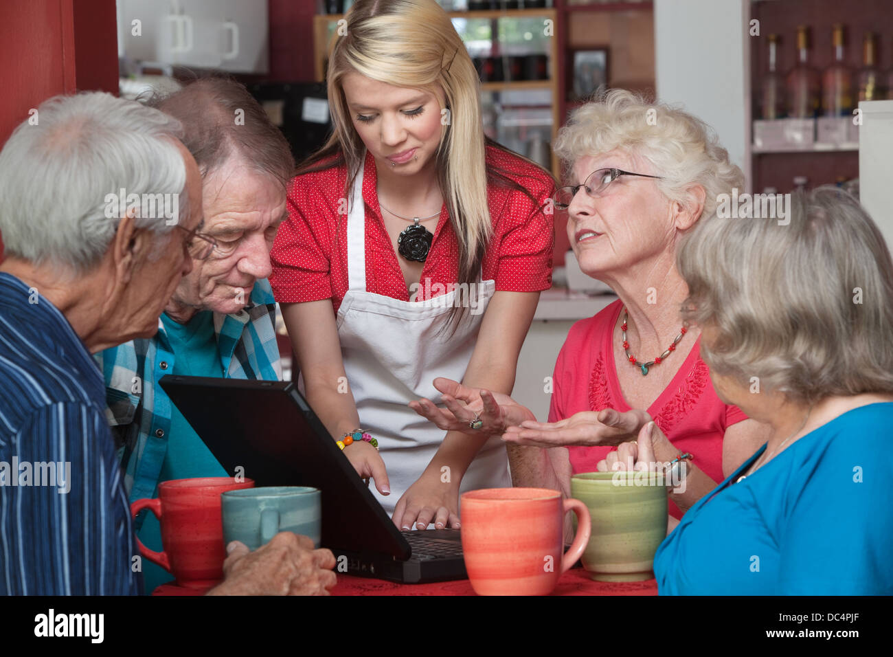 Woman Helping Seniors with Computer Stock Photo - Alamy