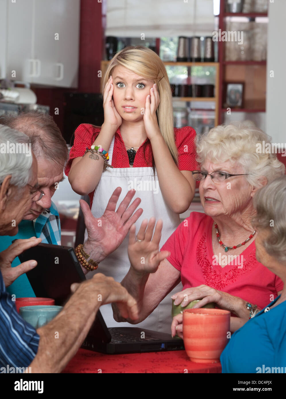 Bickering Seniors and Young Waitress Stock Photo - Alamy
