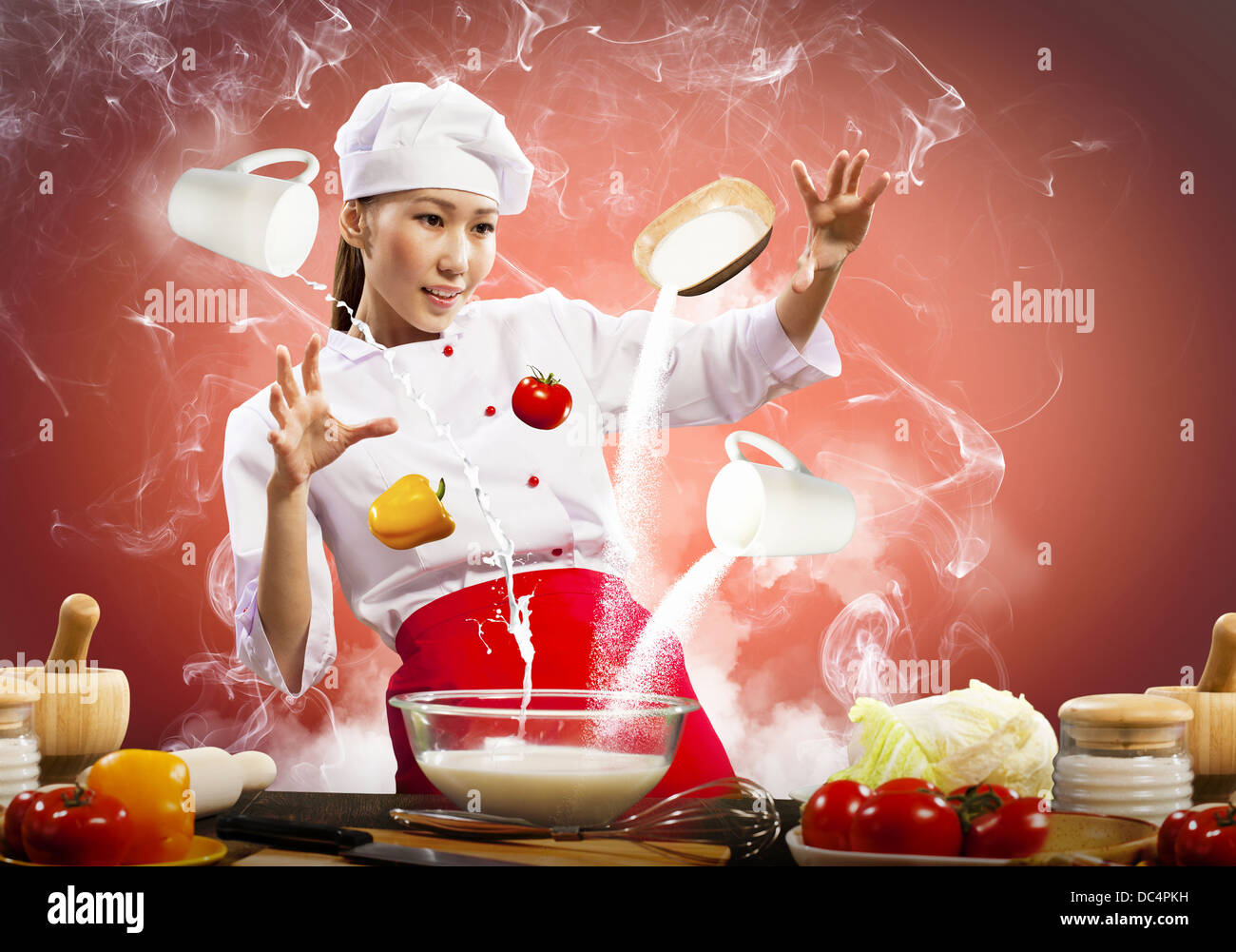 Asian female cooking with magic Stock Photo - Alamy