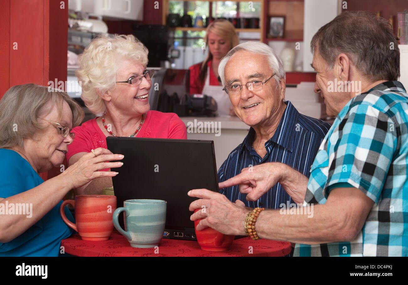 Seniors Having Fun with Computer in Cafe Stock Photo - Alamy