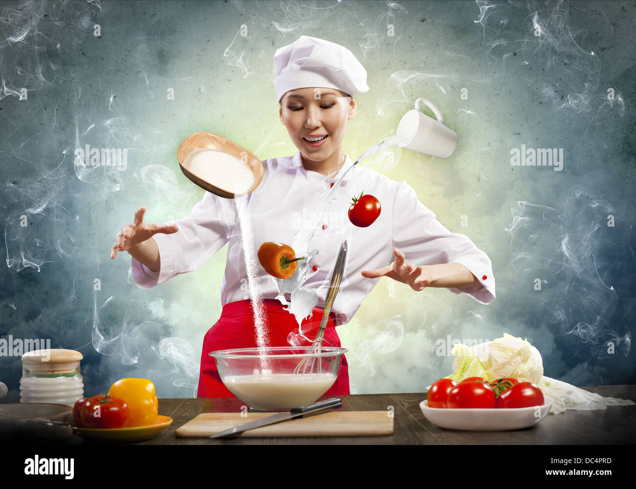 Asian female cooking with magic Stock Photo - Alamy