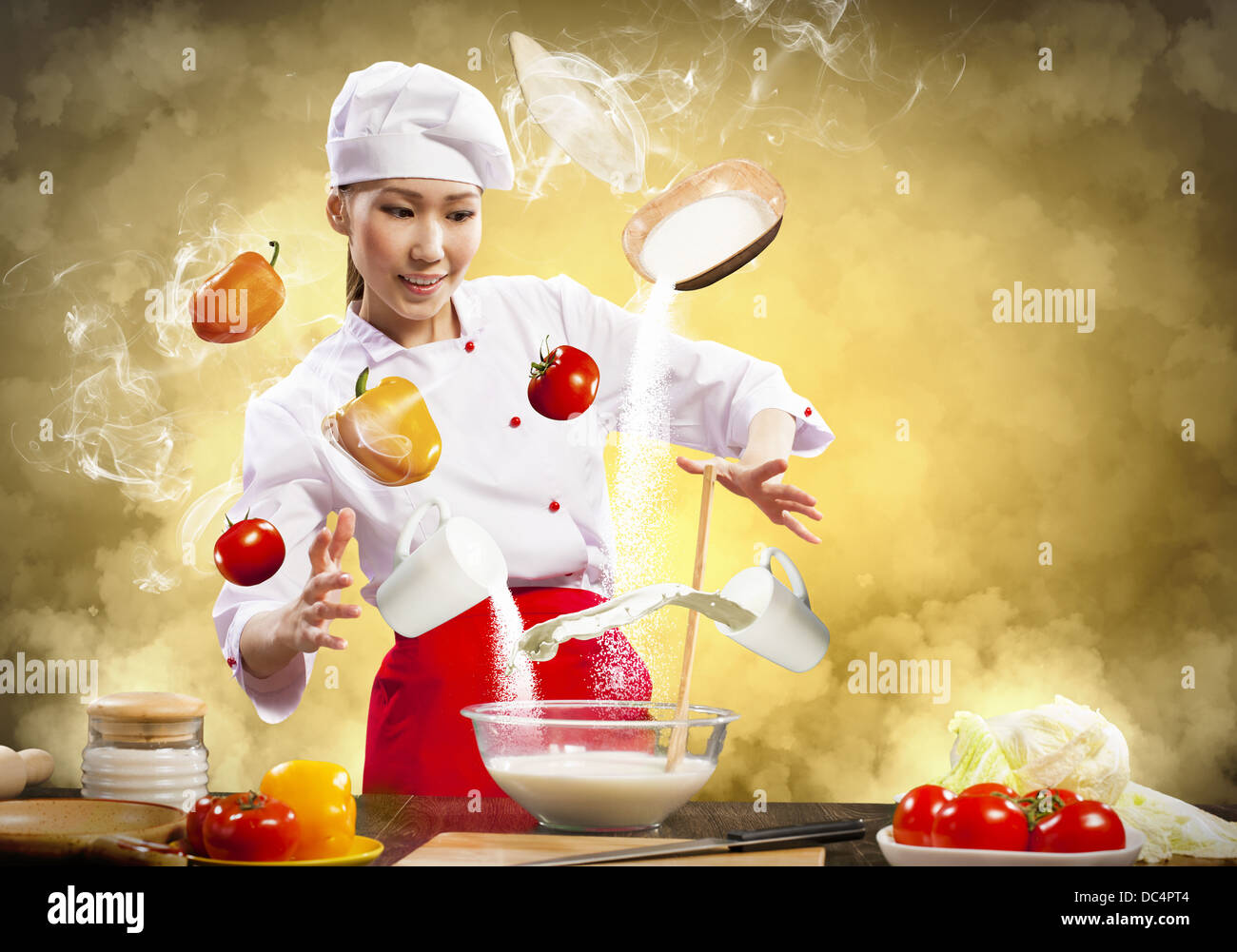 Asian female cooking with magic Stock Photo - Alamy
