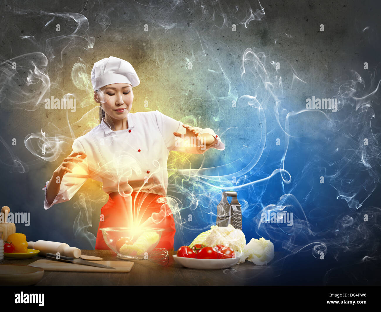 Asian female cooking with magic Stock Photo - Alamy