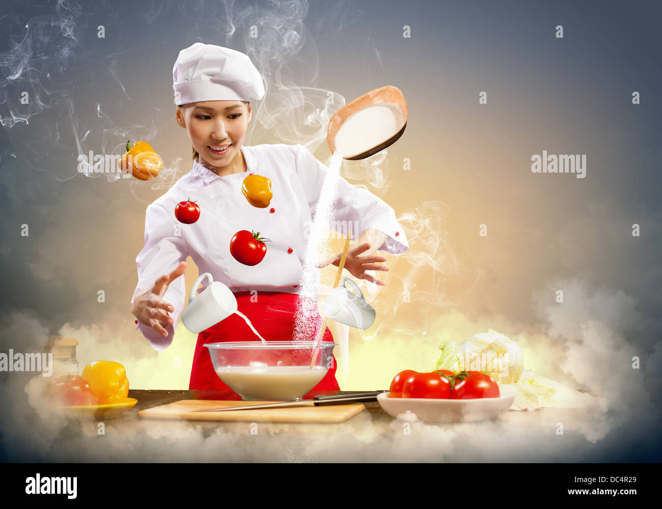 Asian female cooking with magic Stock Photo - Alamy