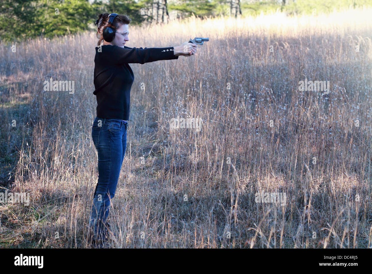 Woman Shooting a Firearm Stock Photo - Alamy