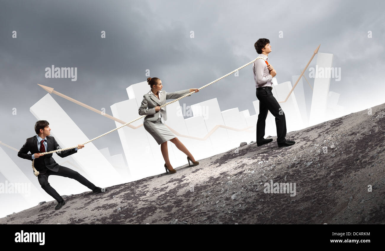 Three business people pulling rope Stock Photo - Alamy