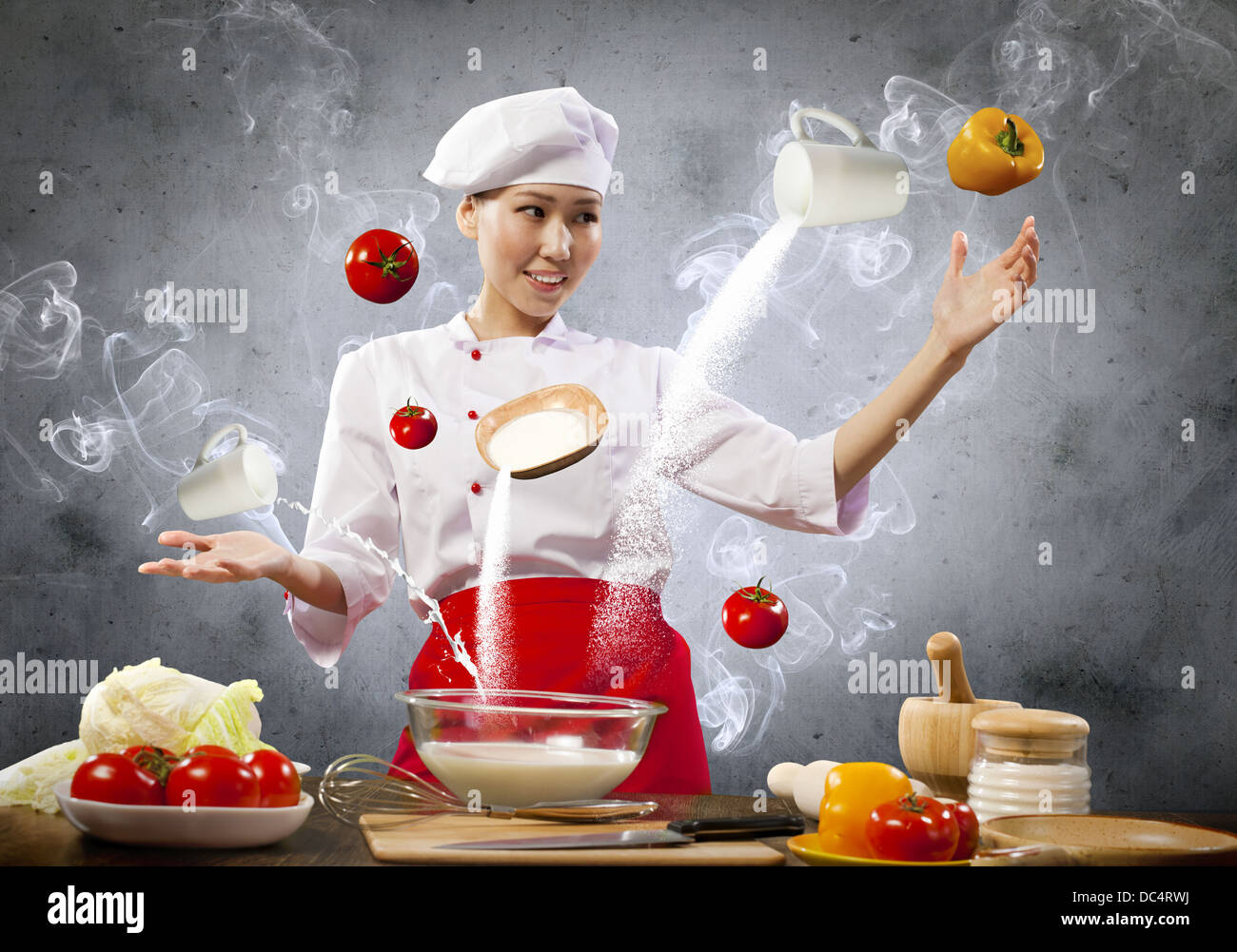 Asian female cooking with magic Stock Photo - Alamy