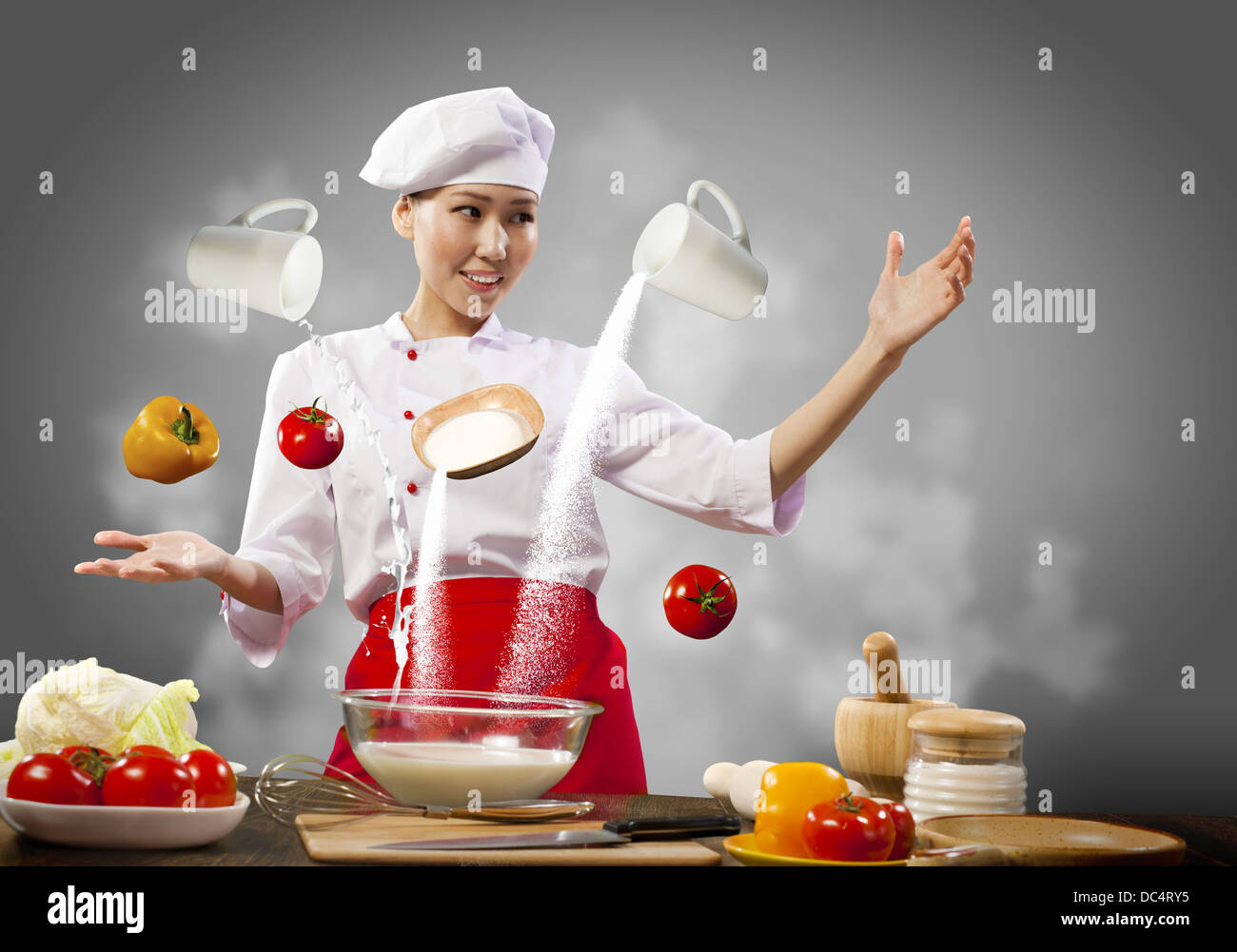 Asian female cooking with magic Stock Photo - Alamy