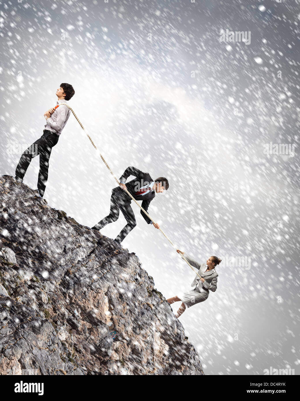 Three business people pulling rope Stock Photo - Alamy