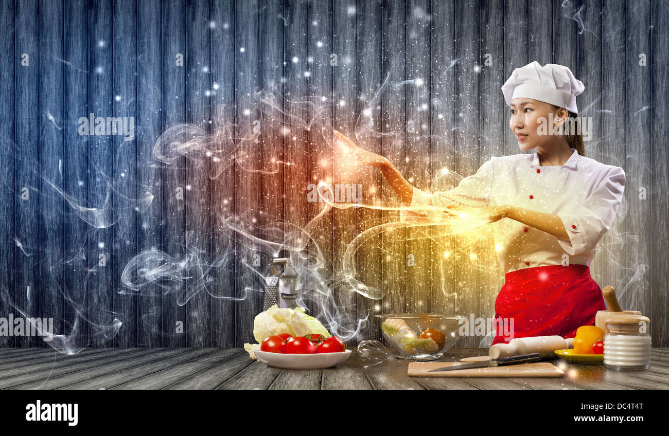 Asian female cooking with magic Stock Photo - Alamy