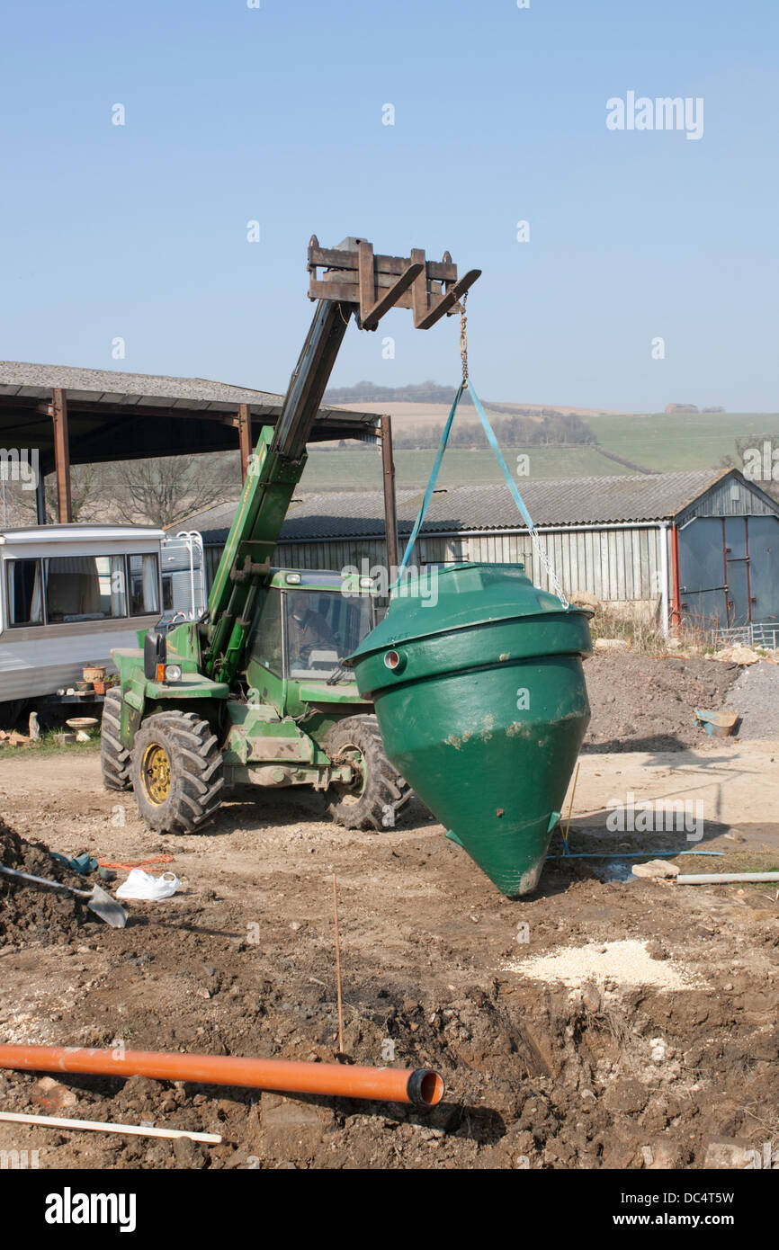 Telescopic handler lifting BioPure septic tank into position UK Stock ...