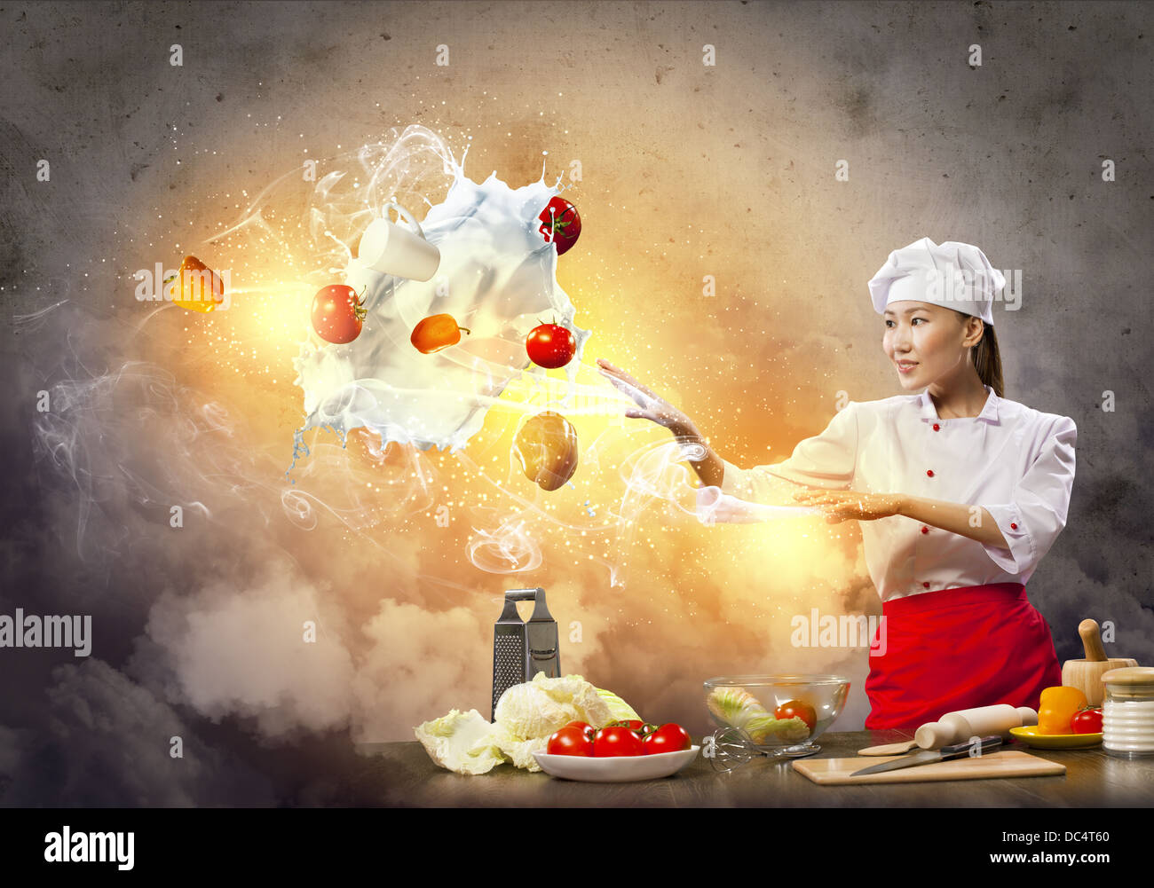 Asian female cooking with magic Stock Photo - Alamy