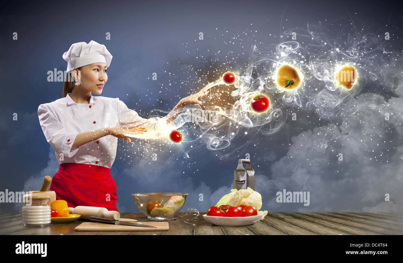 Asian female cooking with magic Stock Photo - Alamy