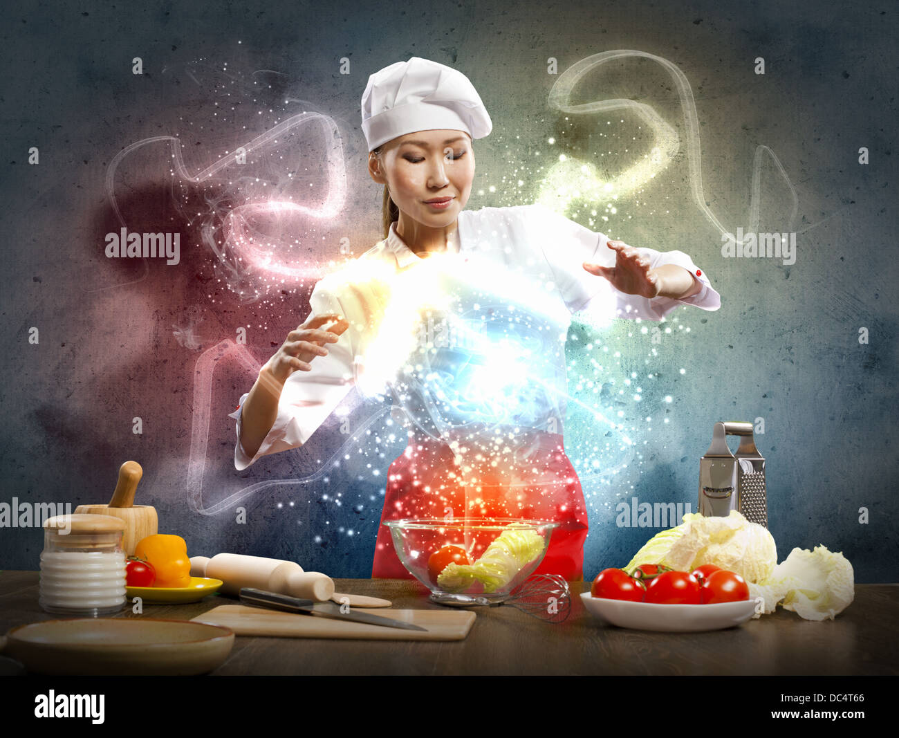Asian female cooking with magic Stock Photo - Alamy