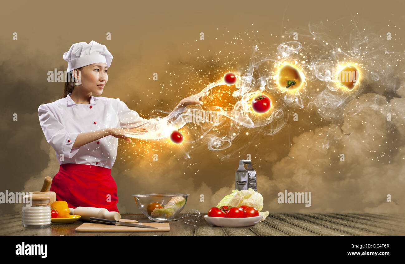 Asian female cooking with magic Stock Photo - Alamy