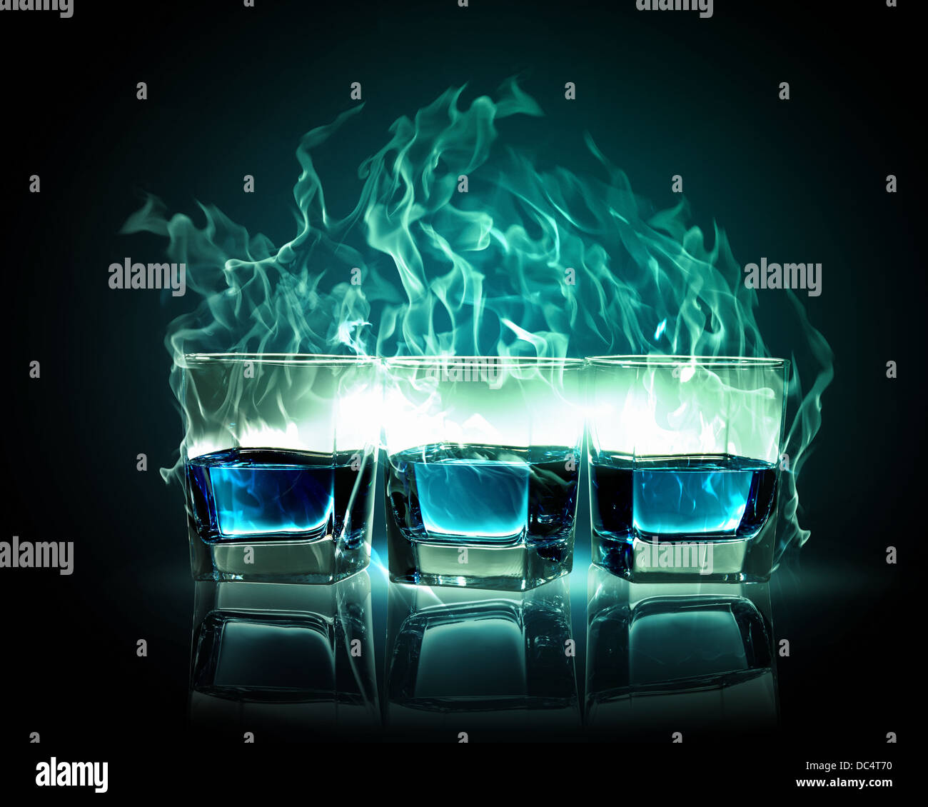 Three glasses of burning emerald absinthe Stock Photo - Alamy