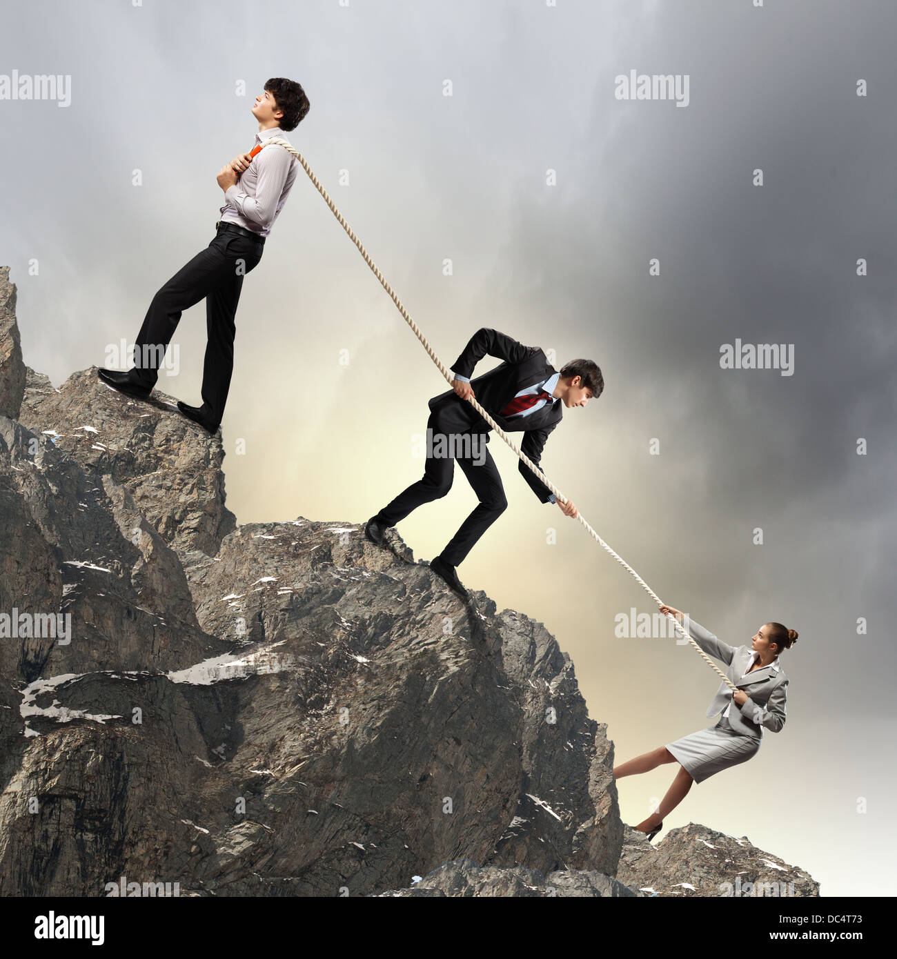 Three business people pulling rope Stock Photo - Alamy