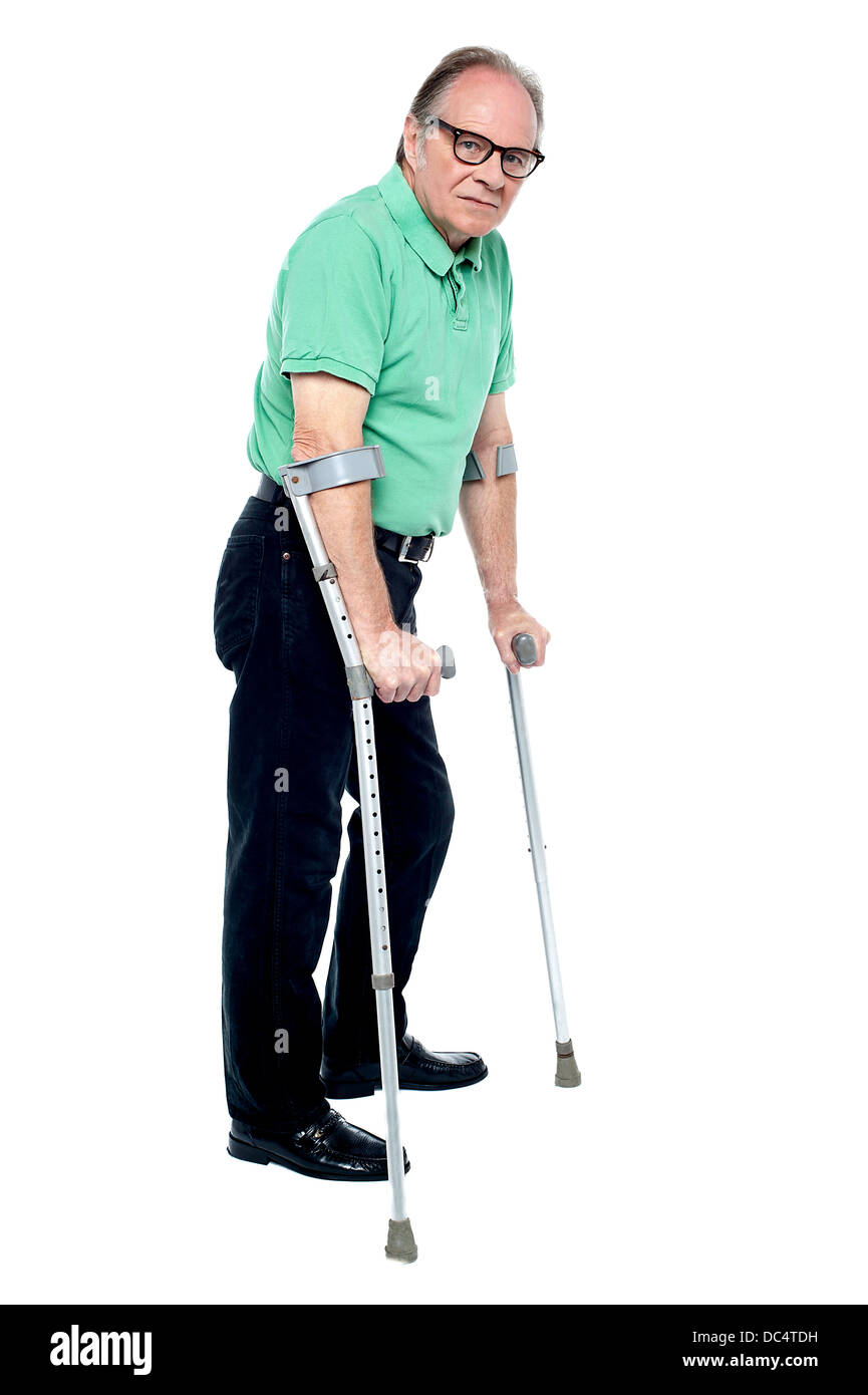 Physically disabled old man with crutches Stock Photo - Alamy