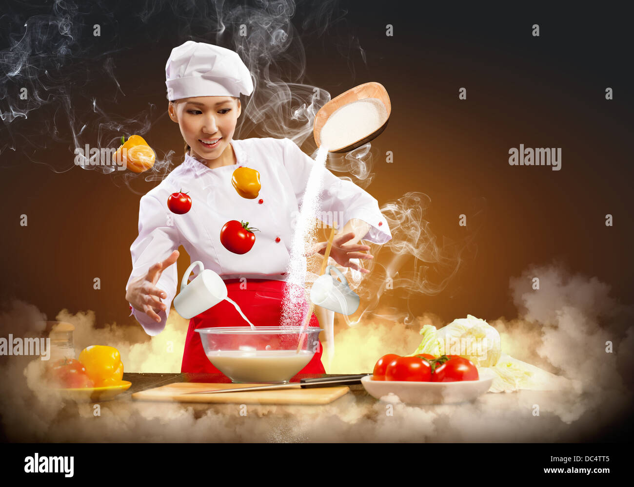 Asian female cooking with magic Stock Photo - Alamy