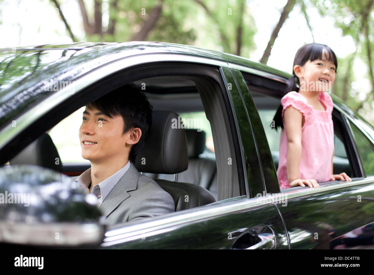 Happy father driving with daughter in car Stock Photo - Alamy
