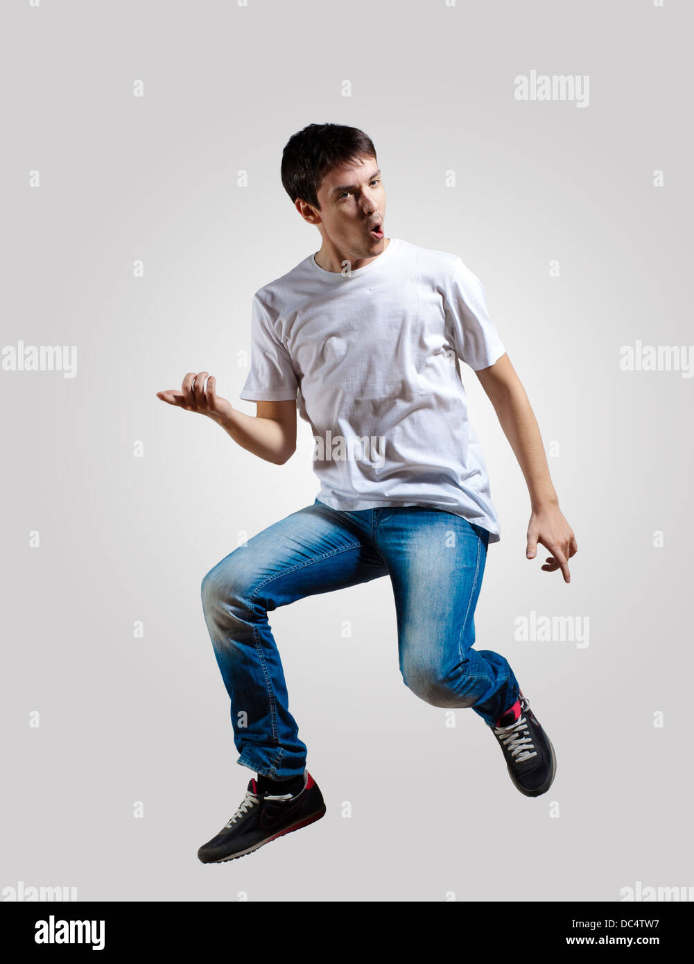 Young man dancing and jumping Stock Photo - Alamy
