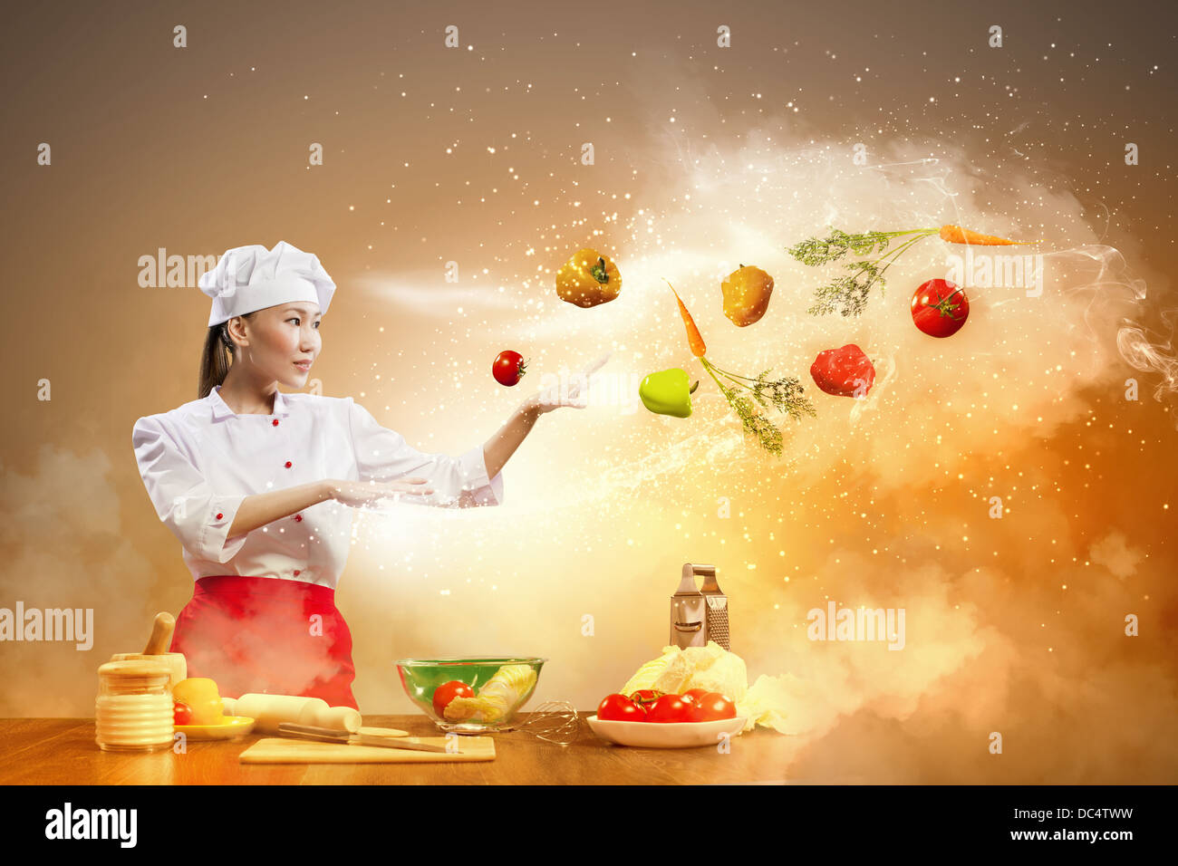 Asian female cooking with magic Stock Photo - Alamy
